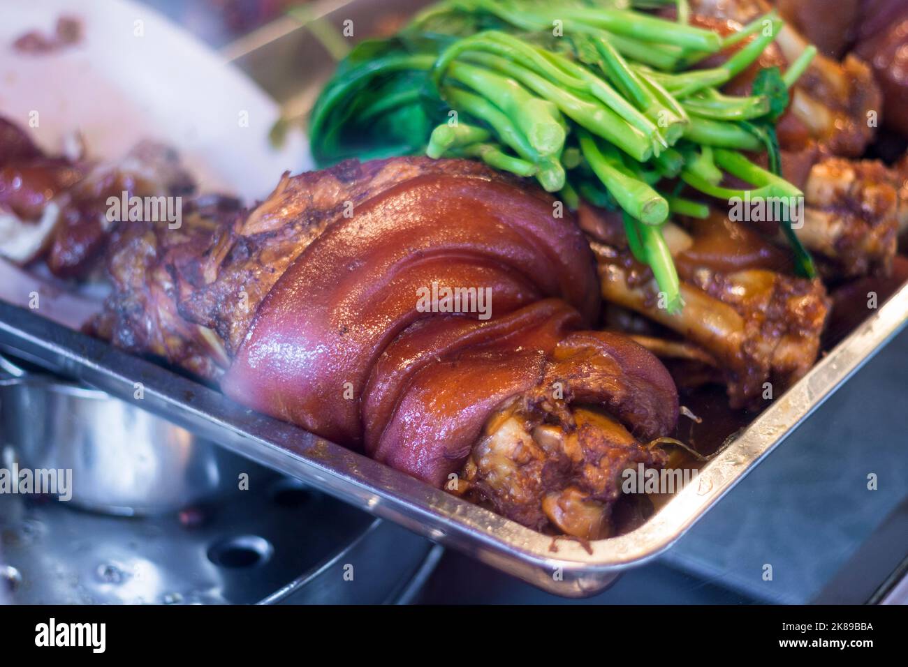 Kao ka moo, a popular Thai street food dish of slow braised pork leg in ...