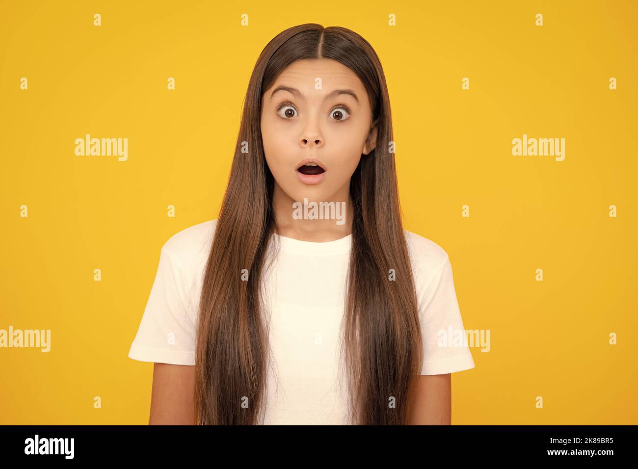 Shocked teenager child portrait isolated on yellow background ...