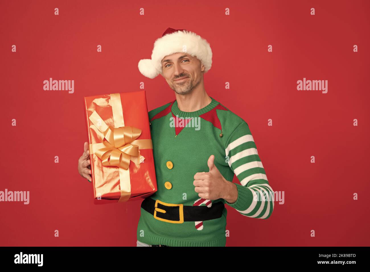 merry christmas gift. thumb up. happy man in elf costume and santa ...