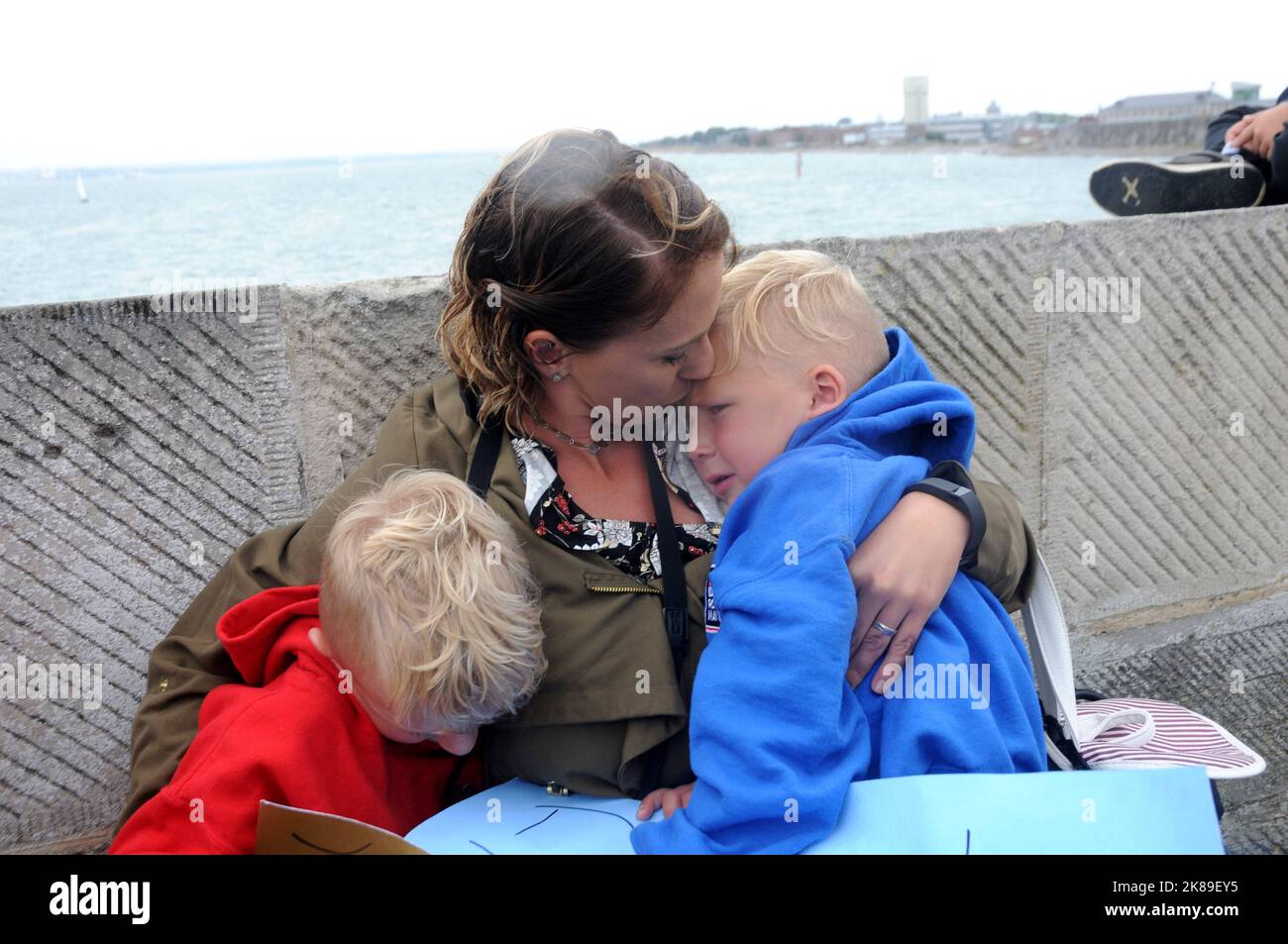 7 year old Jade Nelson qand his brother Austin,5,iare comforted by his ...