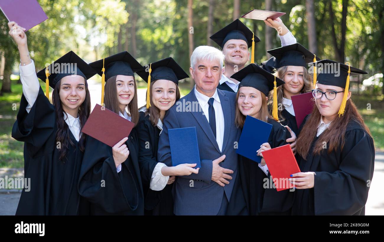 University professor and seven graduates rejoice at graduation Stock ...