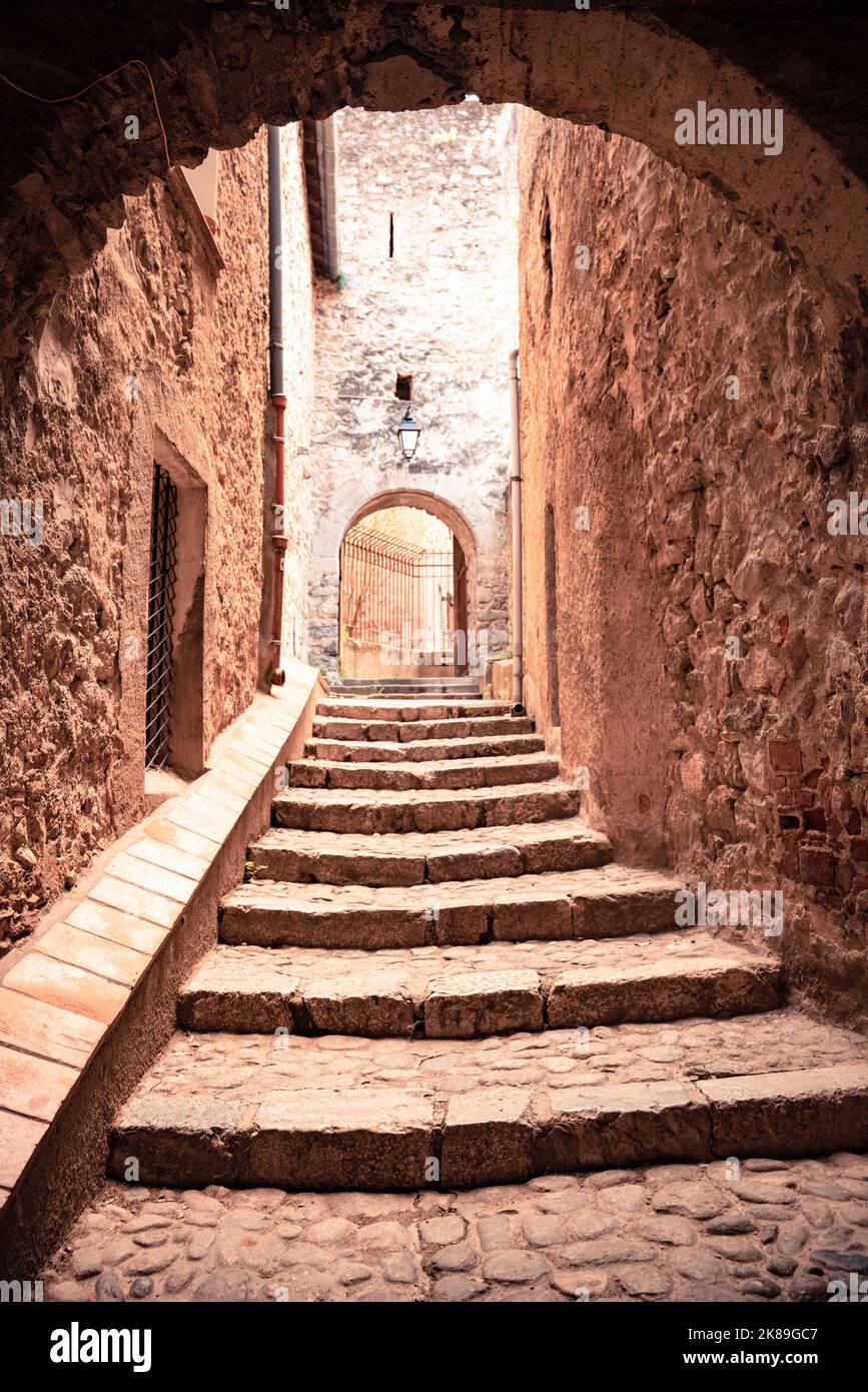 Old stone Ancient European medieval passageway alley with steps and ...