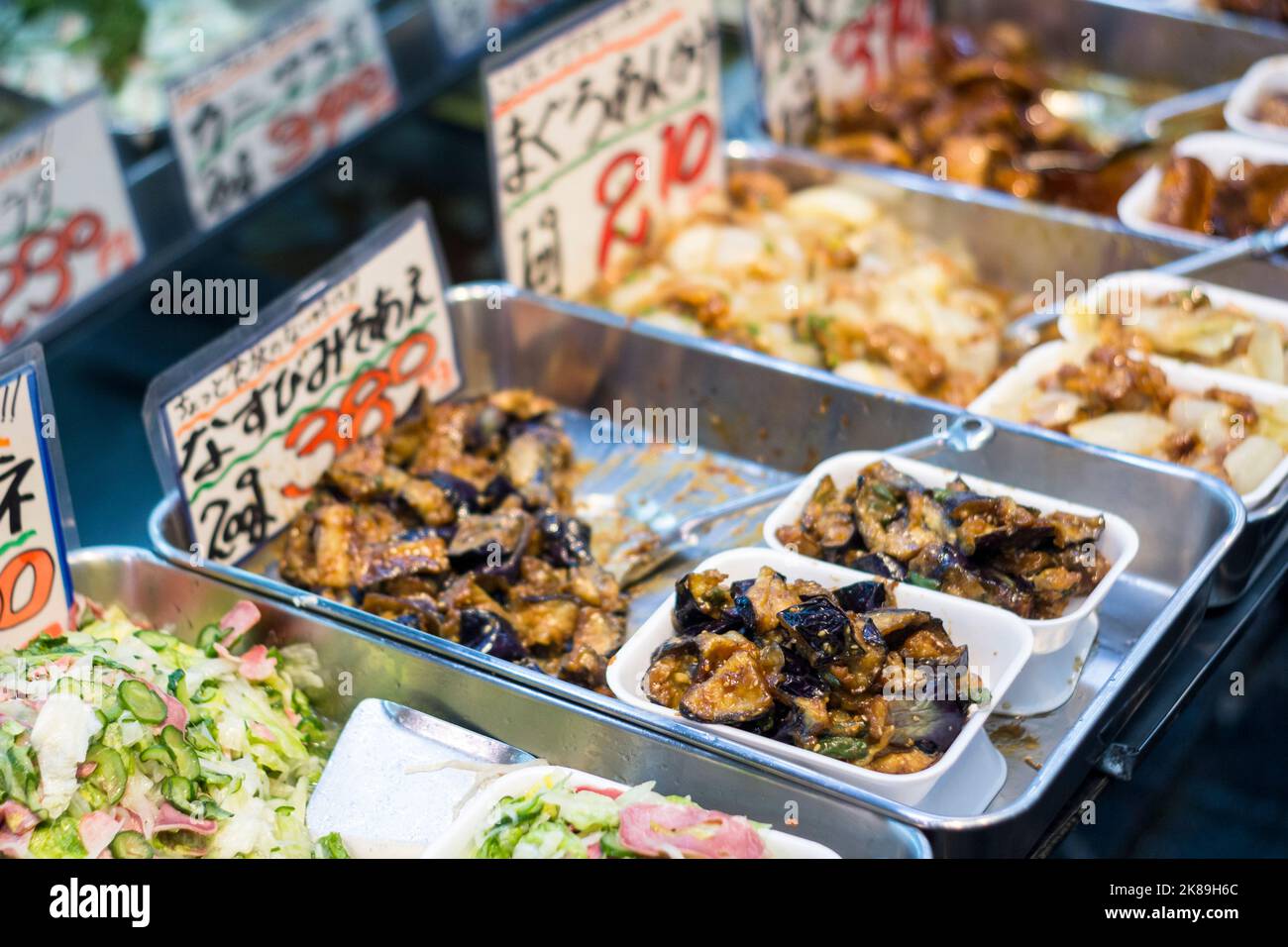 Different types of street food at a market in Osaka, Japan Stock Photo ...