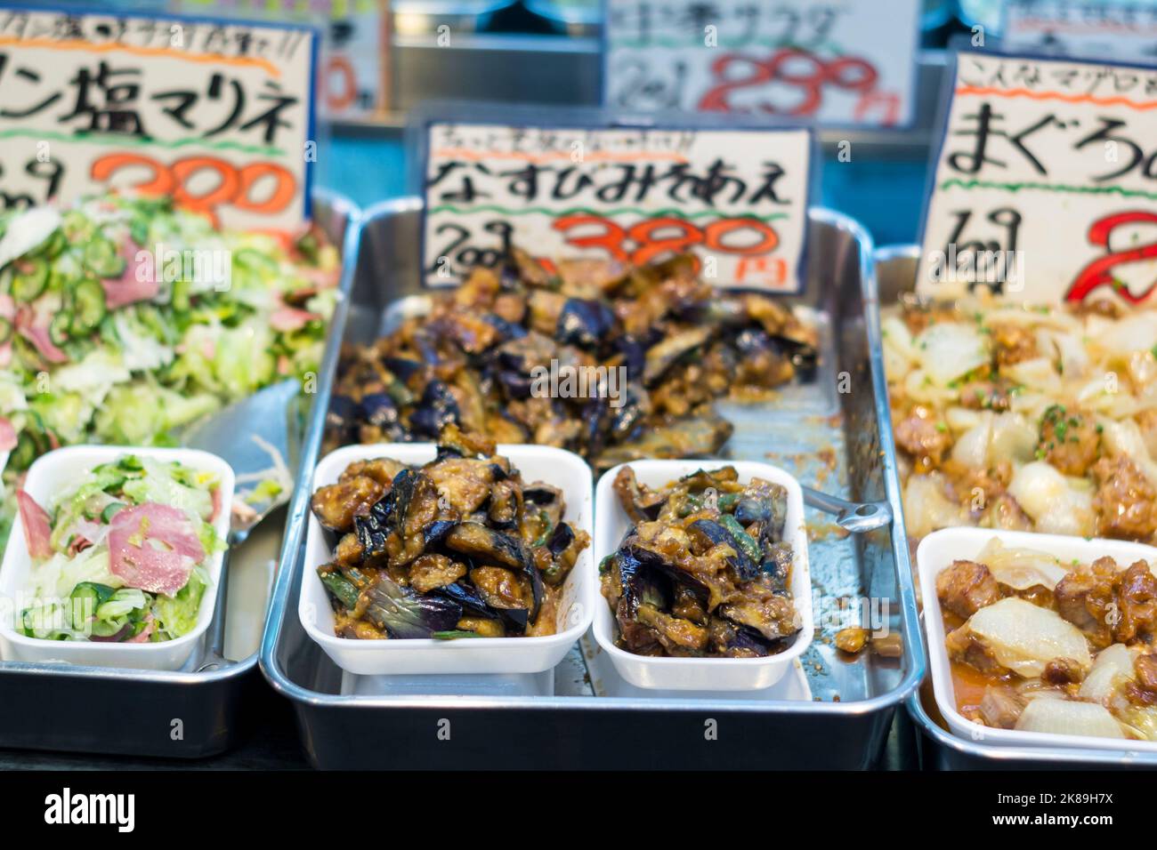 Different types of street food at a market in Osaka, Japan Stock Photo ...