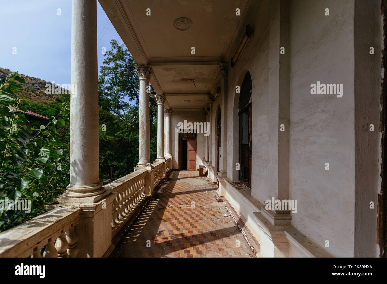 Old overgrown balcony of abandoned mansion Stock Photo - Alamy
