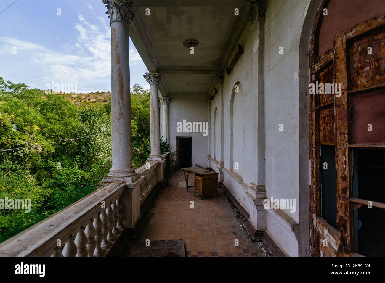 Old overgrown balcony of abandoned mansion Stock Photo - Alamy