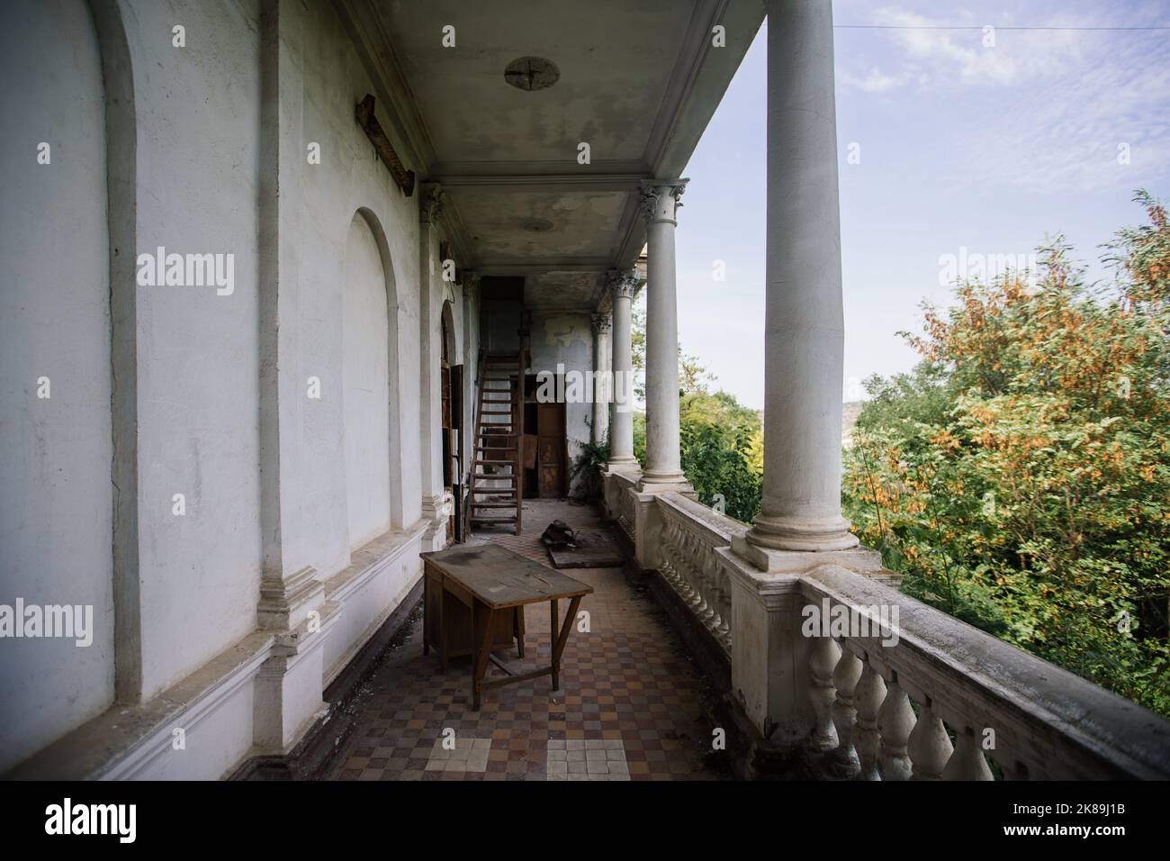 Old overgrown balcony of abandoned mansion Stock Photo - Alamy