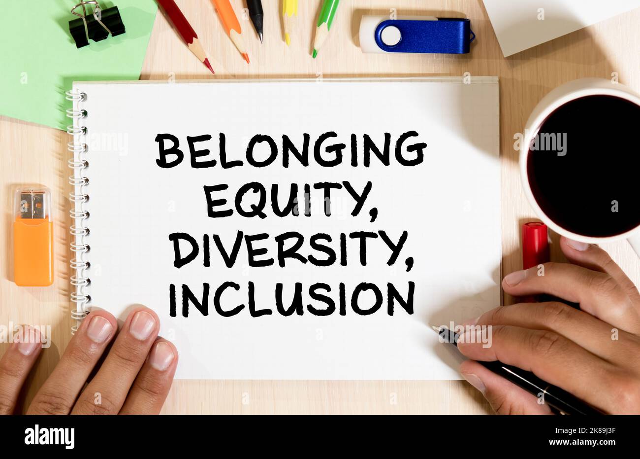 Equity, identity, diversity, inclusion, belonging. Man holding a paper ...