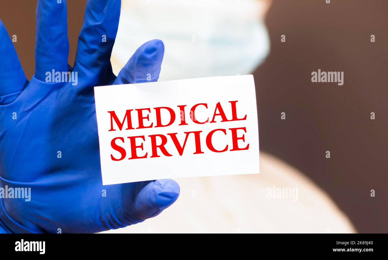 Medical concept. On a green surface, an ambulance, pills and a sign ...