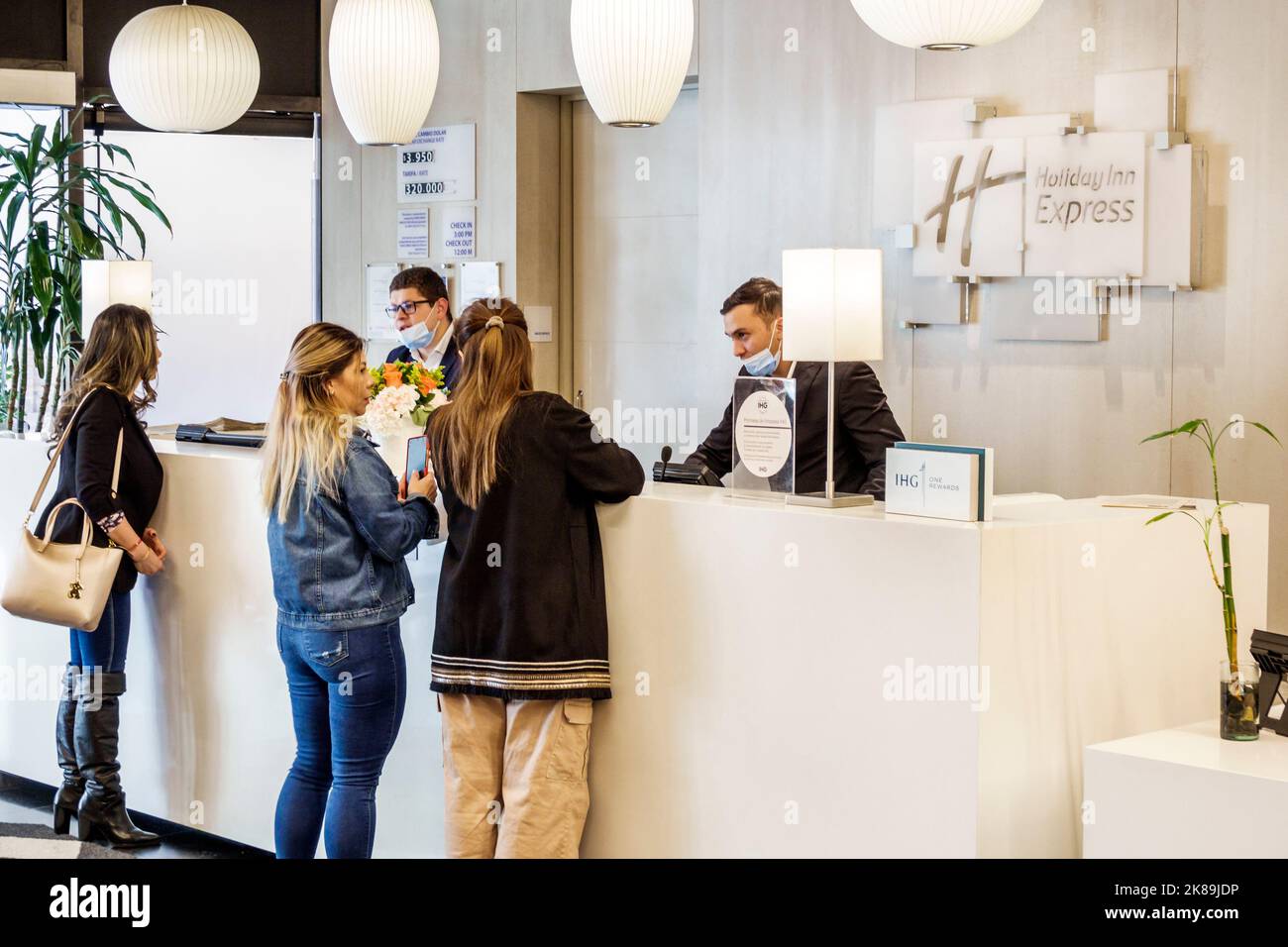 Front desk check in reservation reservations reception counter agent lobby hi-res stock ...