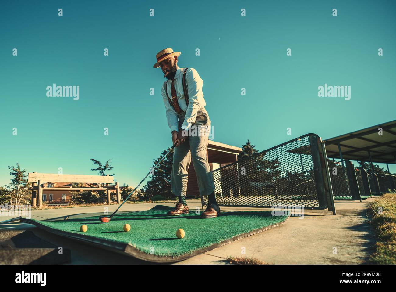 View of a dapper African guy with a black beard and a cigar in his ...
