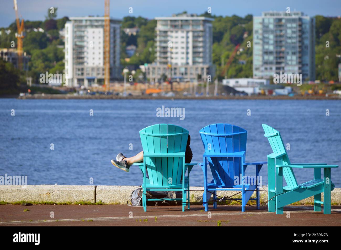 People lounge in colourful seating, Adirondack chairs (Muskoka chairs ...