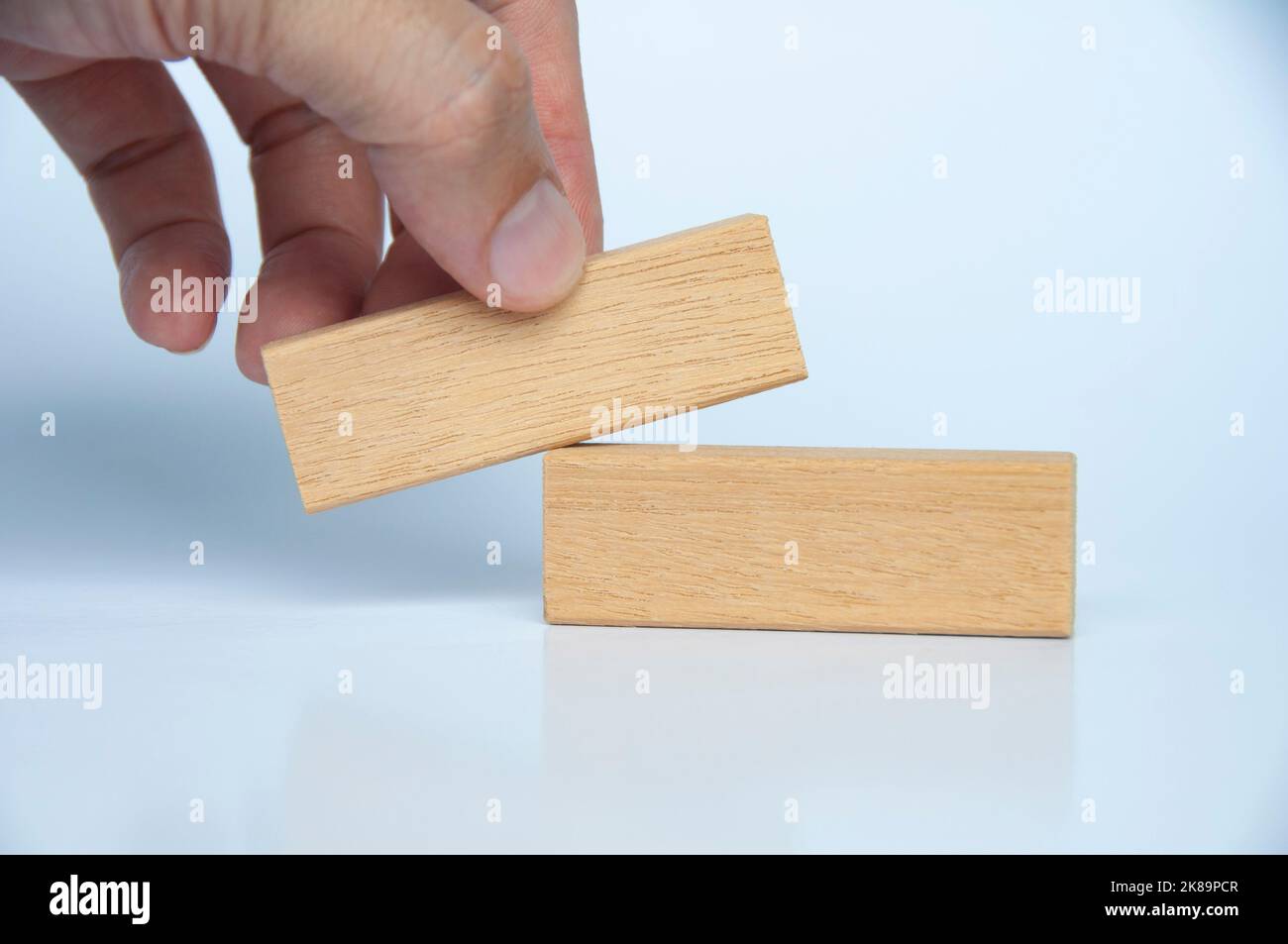 Hand holding wooden block with customizable space for text or ideas ...