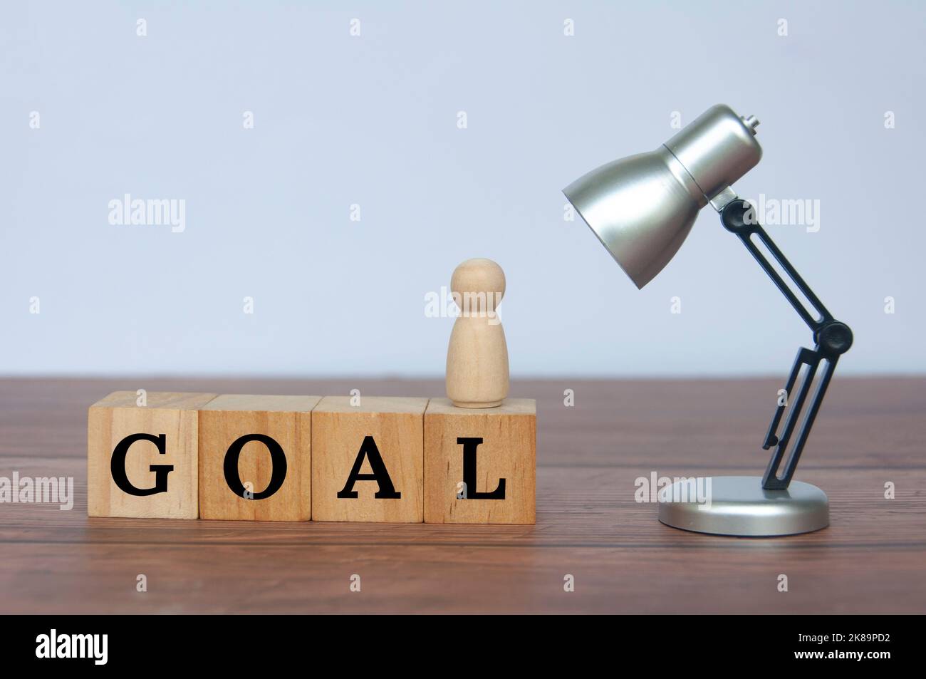 Goal text on wooden cubes with table lamp background. Goal setting ...