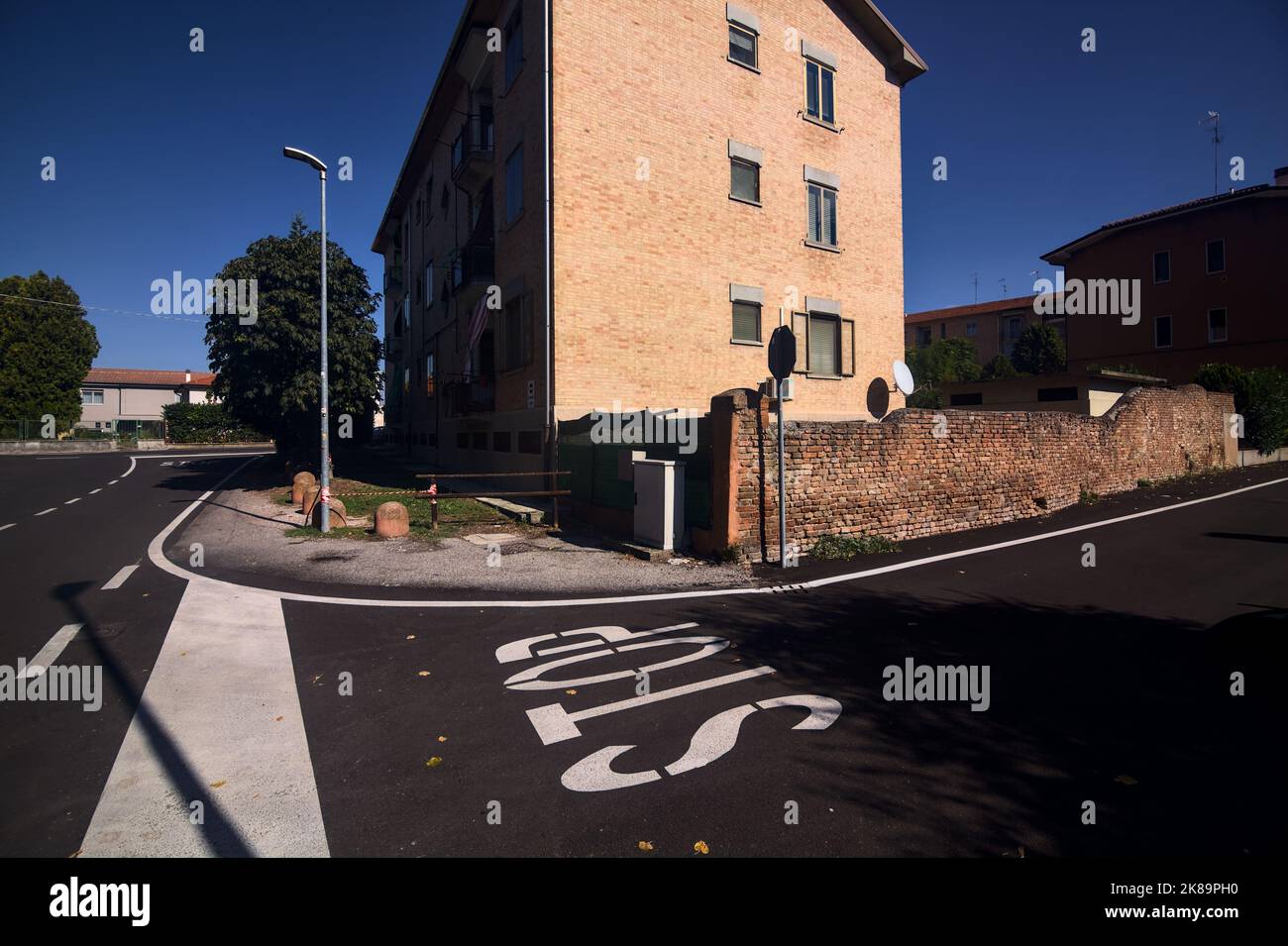 Corner of a street with stop sign on the ground in a residential area ...