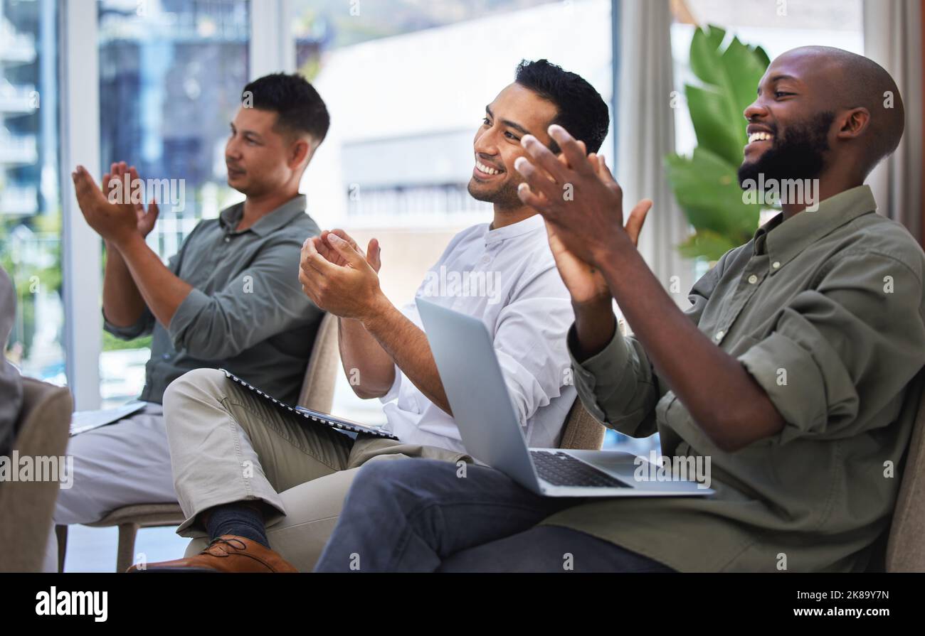 Job well done. a group of people clapping and smiling during a meeting ...