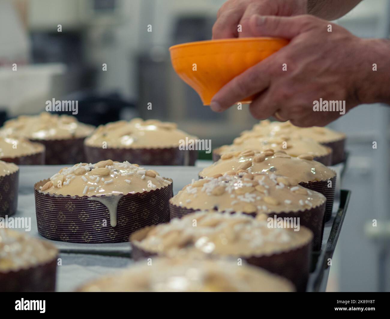 chef topping panettone italian cake with almonds Stock Photo - Alamy