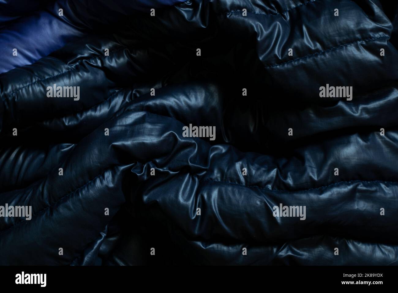 black puffed men's winter jacket as background, down jacket close-up ...