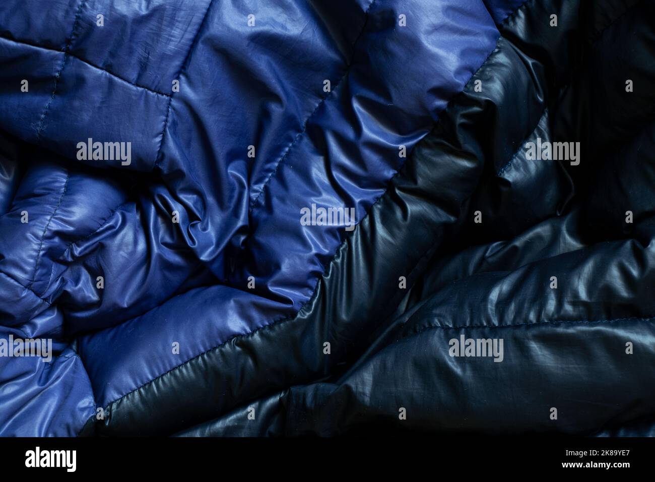 black puffed men's winter jacket as background, down jacket close-up ...