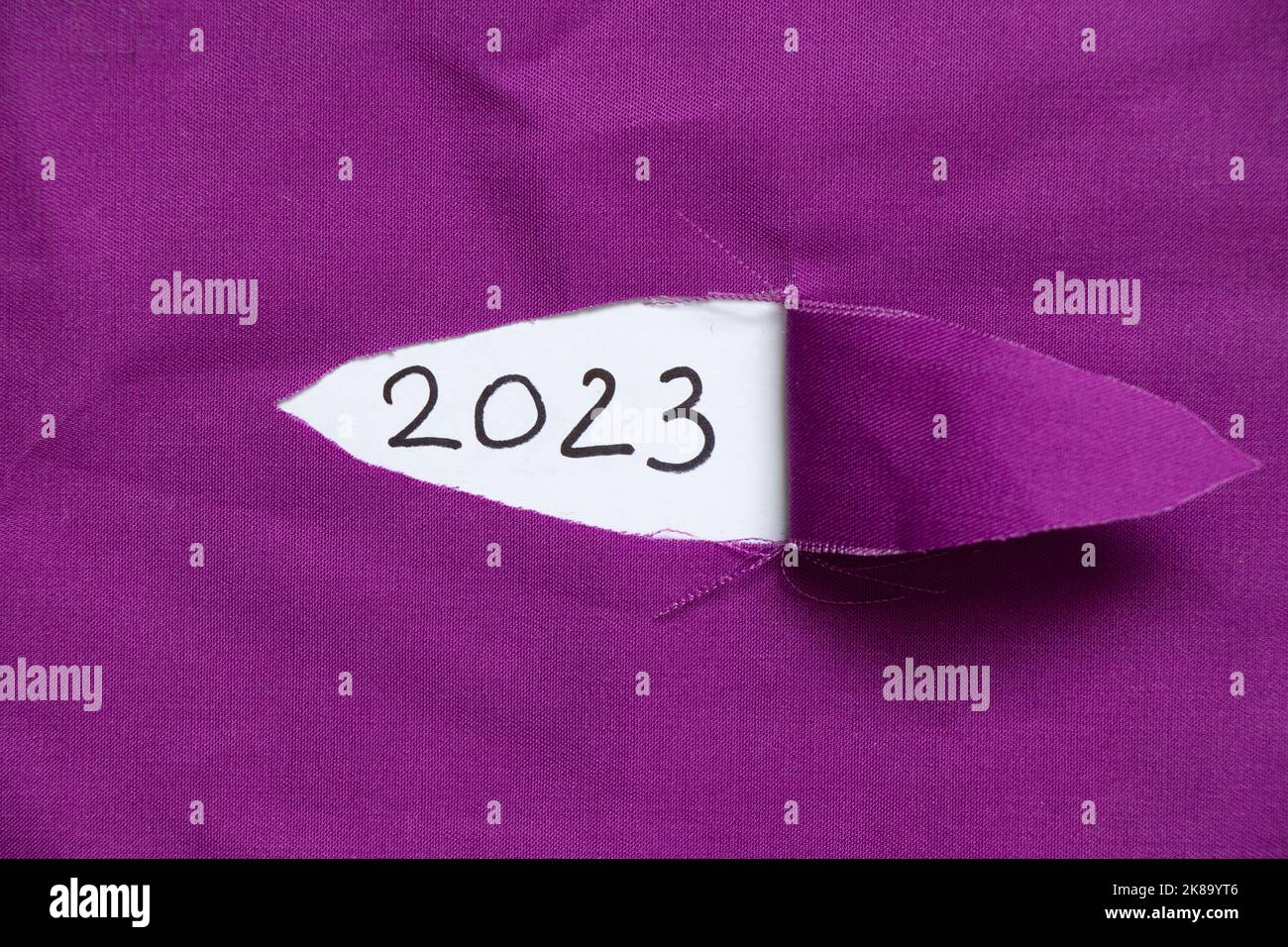 2023 written on paper on torn fabric, happy new year 2023 Stock Photo ...