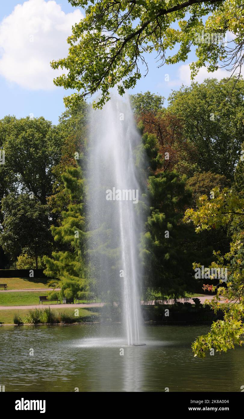 high jet of water from the fountain in the middle of the pond in the ...