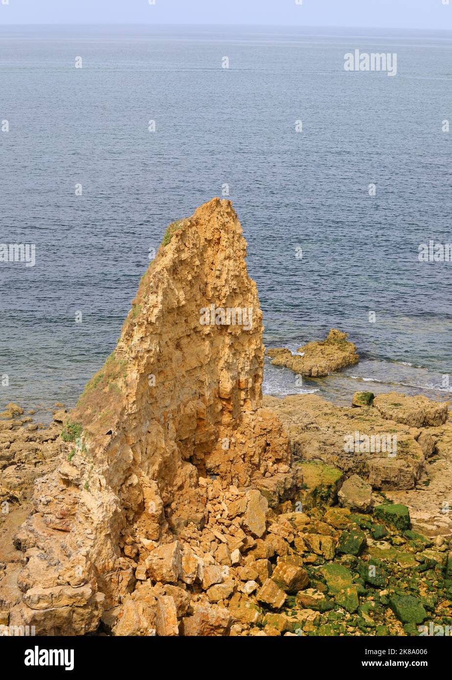 rock collapsed due to erosion due to wave motion by the sea Stock Photo ...