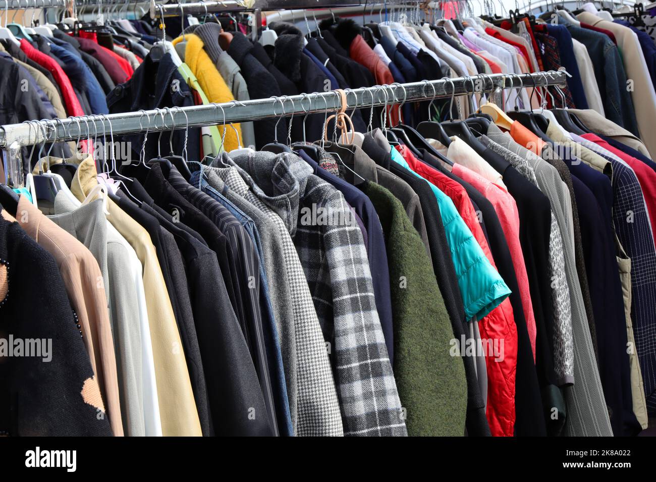 vintage used clothes and new dresses in the stall at the flea market ...