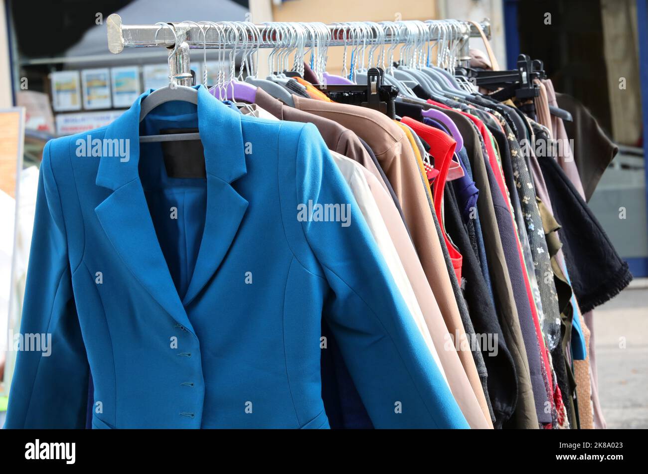 vintage used clothes and new dresses in the stall at the flea market ...