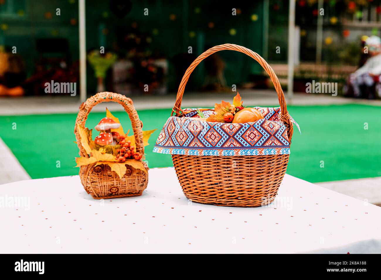 Autumn composition baskets with autumn leaves and berries stand on a ...