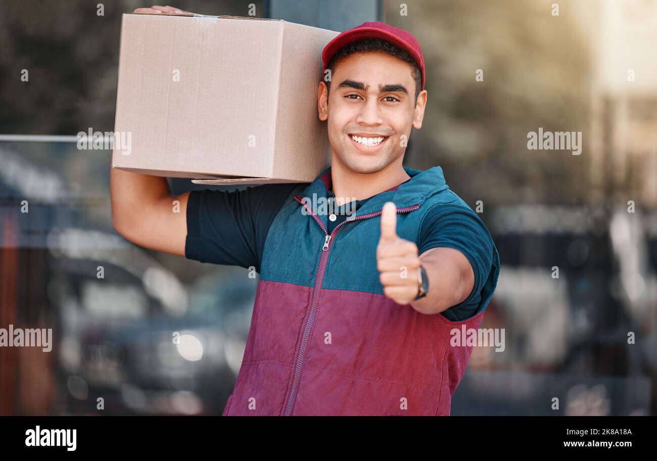 Portrait, box and delivery worker with thumbs up gesture and a big ...