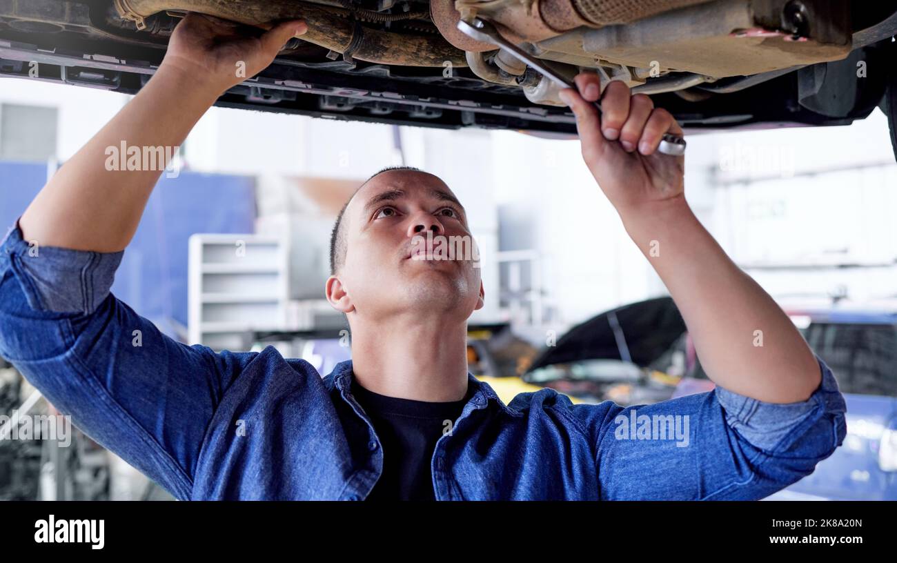 Mechanic, engineer and car with a man at work in a garage or service ...