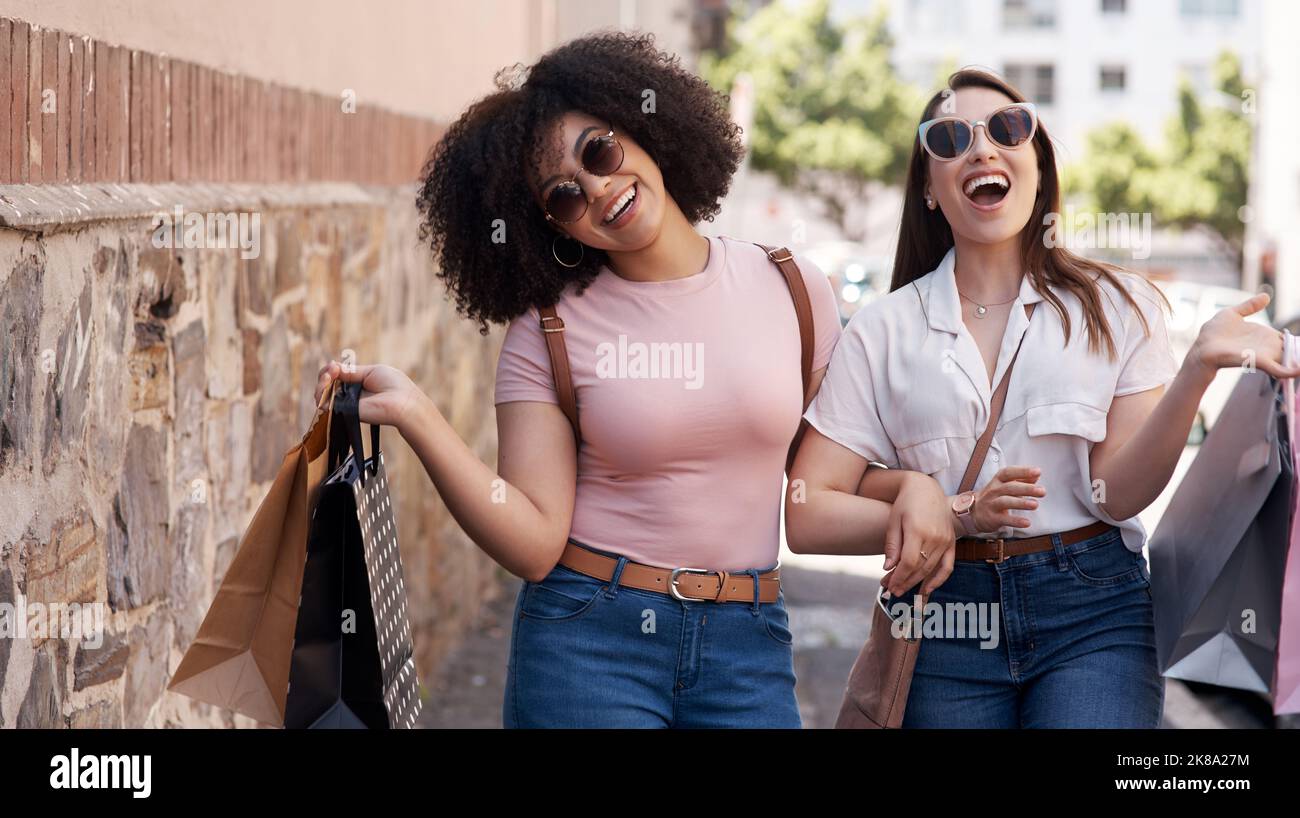 Were on a retail rampage. two young women carrying a bunch of shopping ...