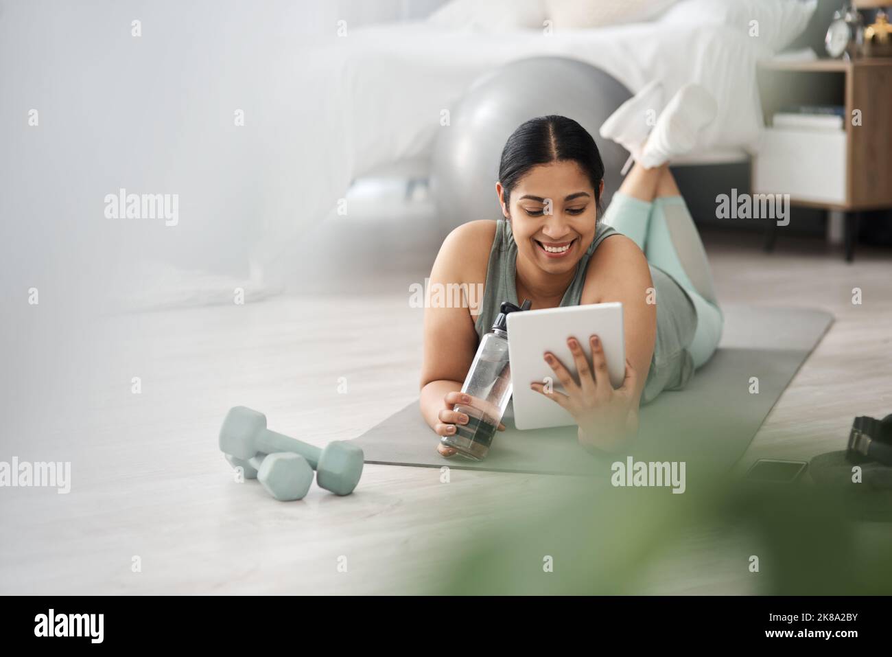 Checking out whats new on her favourite fitness blogs. a sporty young ...