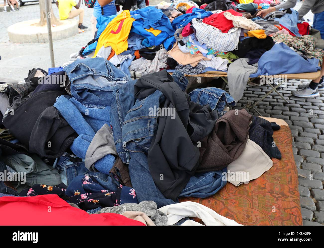 pile of lots of used clothes in the flea market in the town square ...