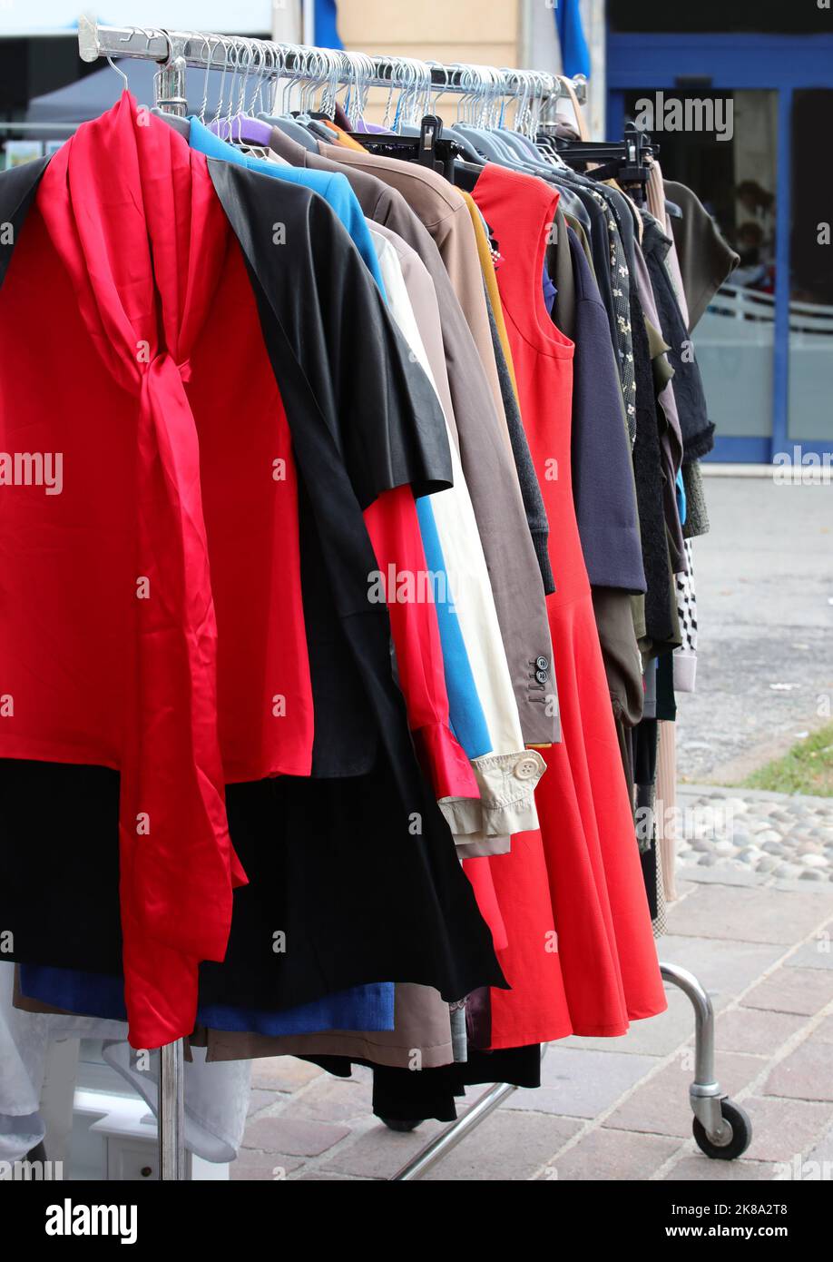 vintage used clothes and new dresses in the stall at the flea market ...