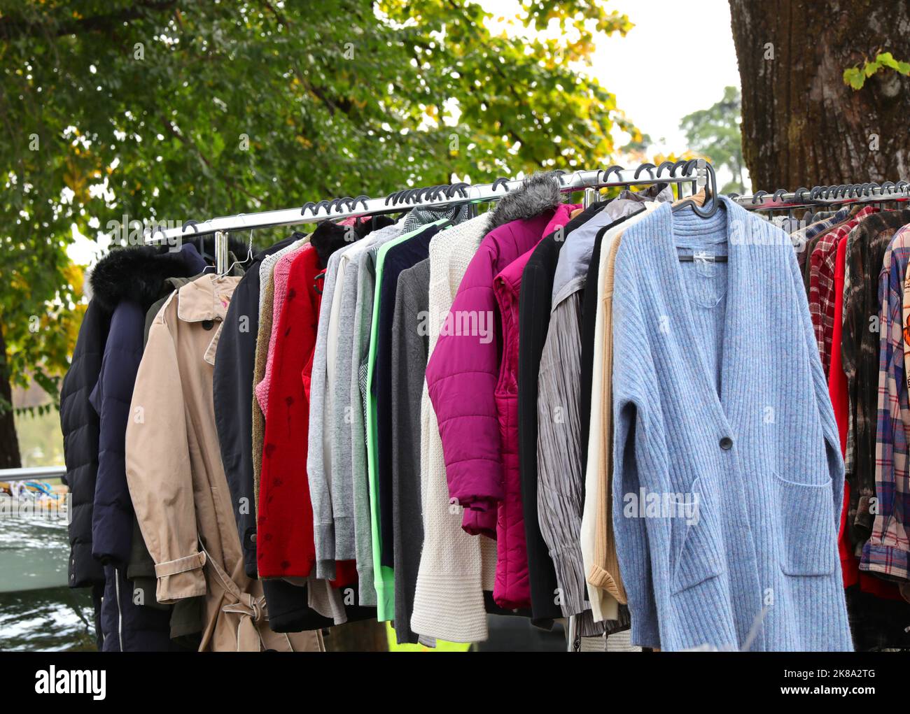 vintage used clothes and new dresses in the stall at the flea market ...