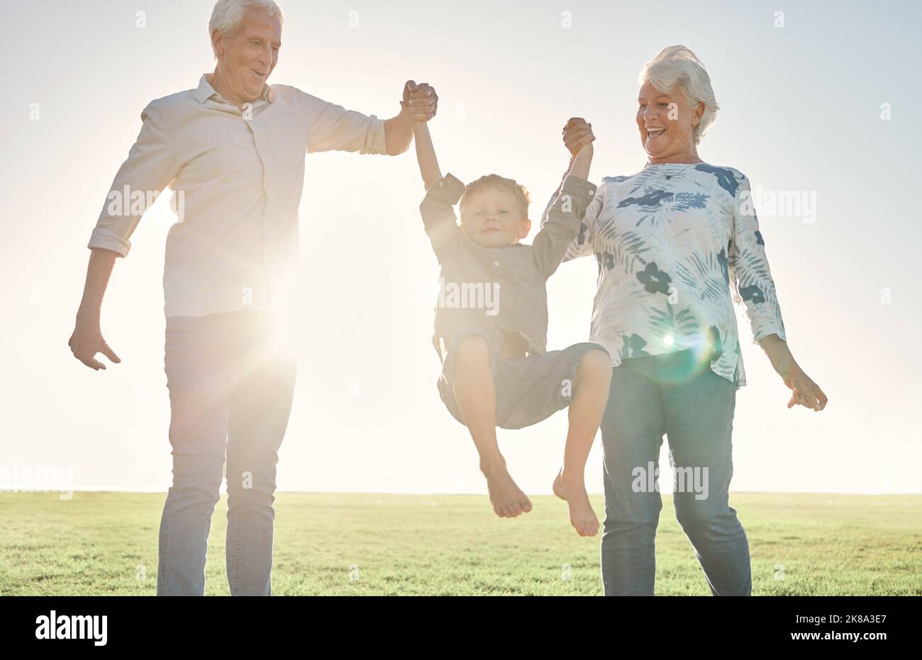 Family, holding hands and grandparents with boy in park, nature or ...
