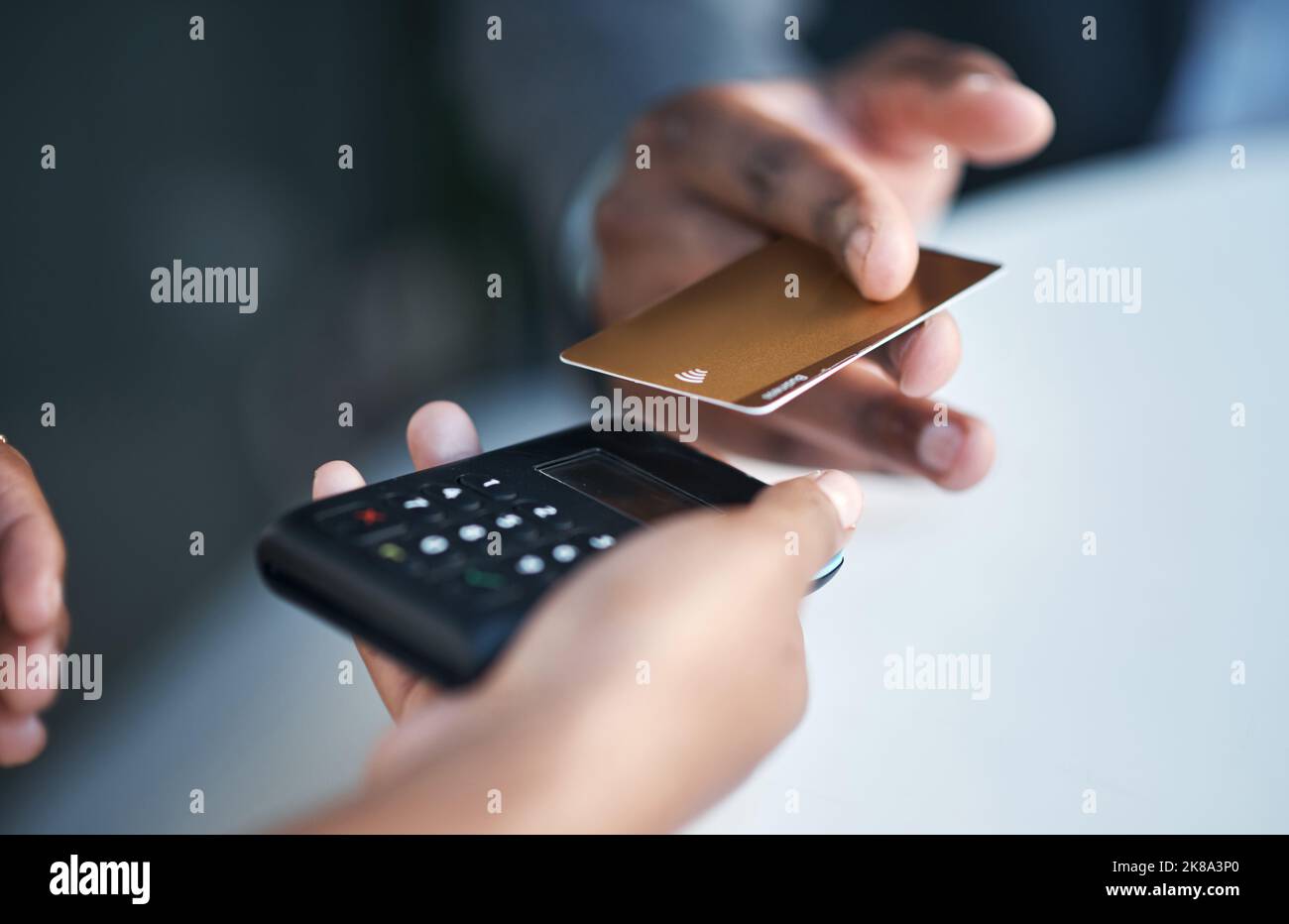 Invest in your goals. two unrecognizable businesspeople using a card ...