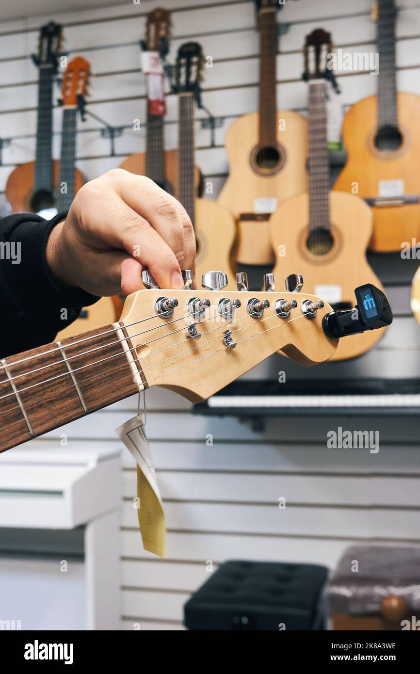 Guitar tuning in a music store Stock Photo - Alamy