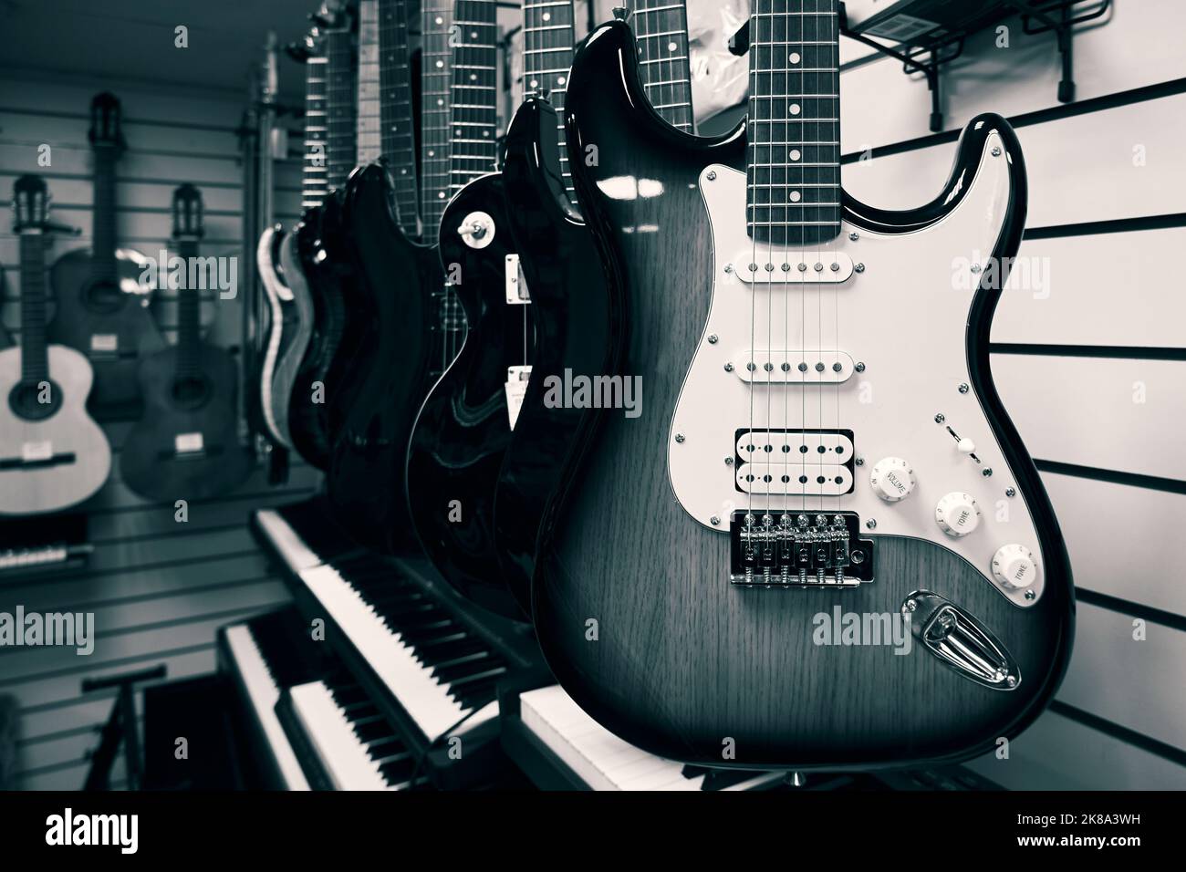 Electric guitars on a showcase in a store. Inside the music store Stock ...