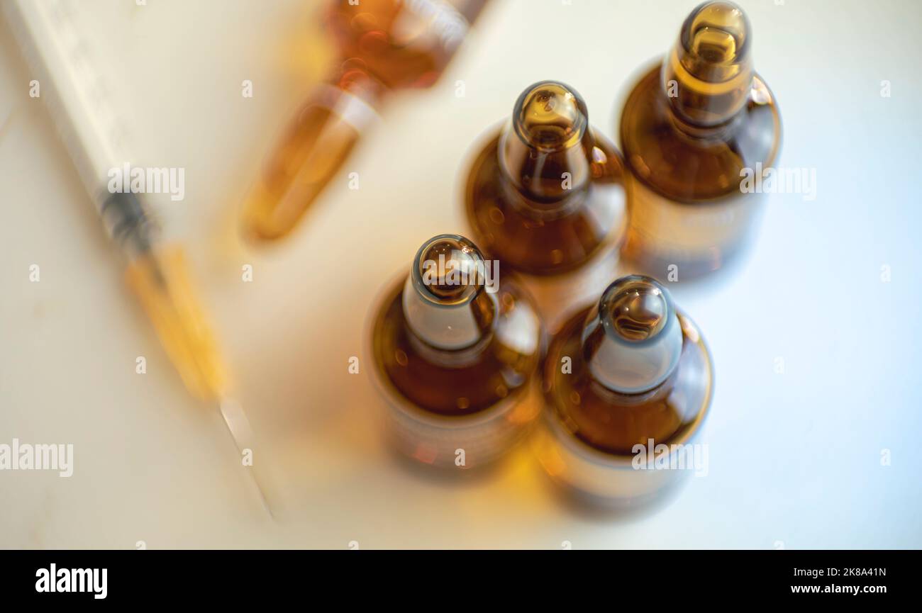 Medicine composition of five injection vials and syringe on white table ...