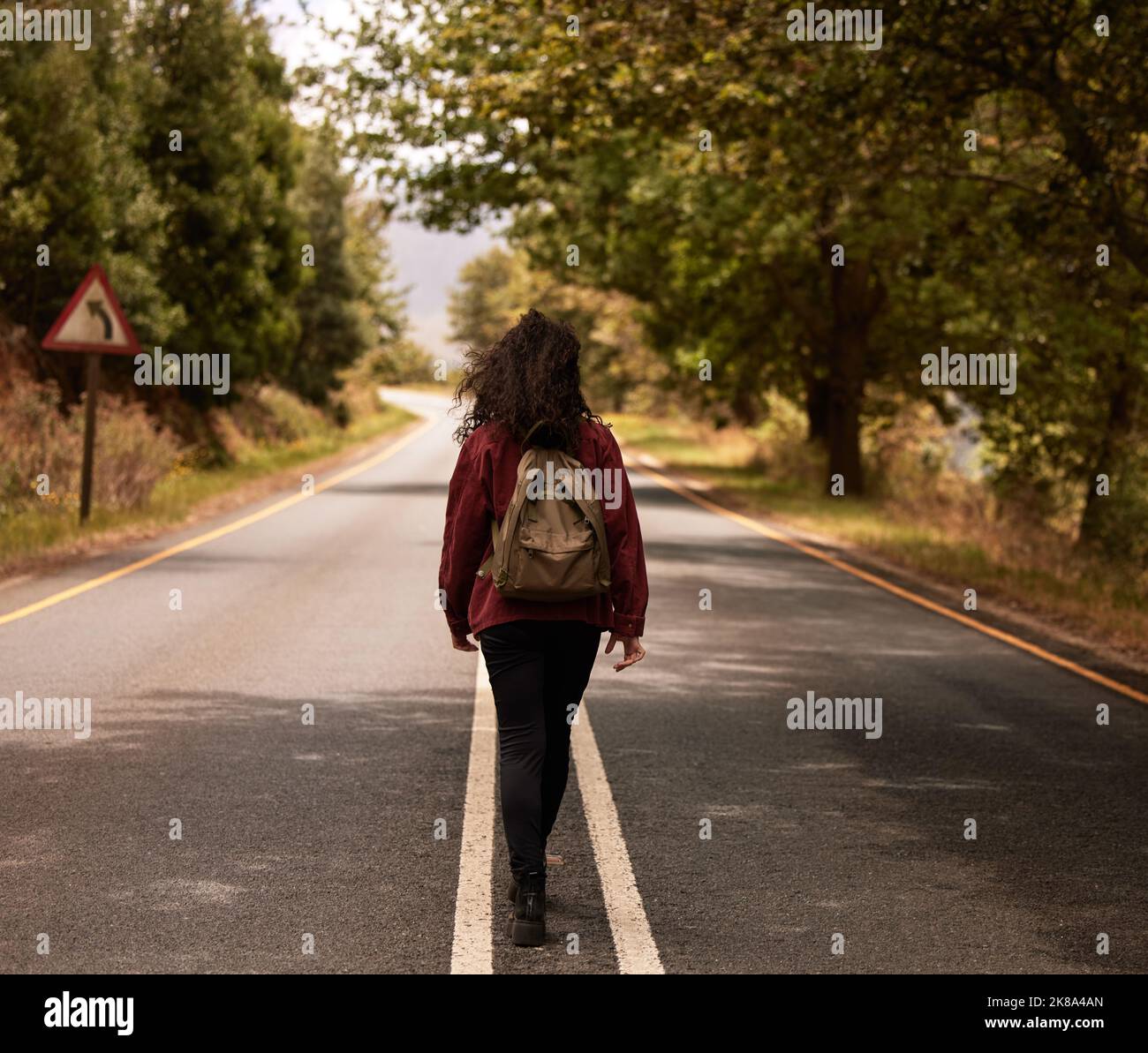 Woman walking down road hi-res stock photography and images - Alamy