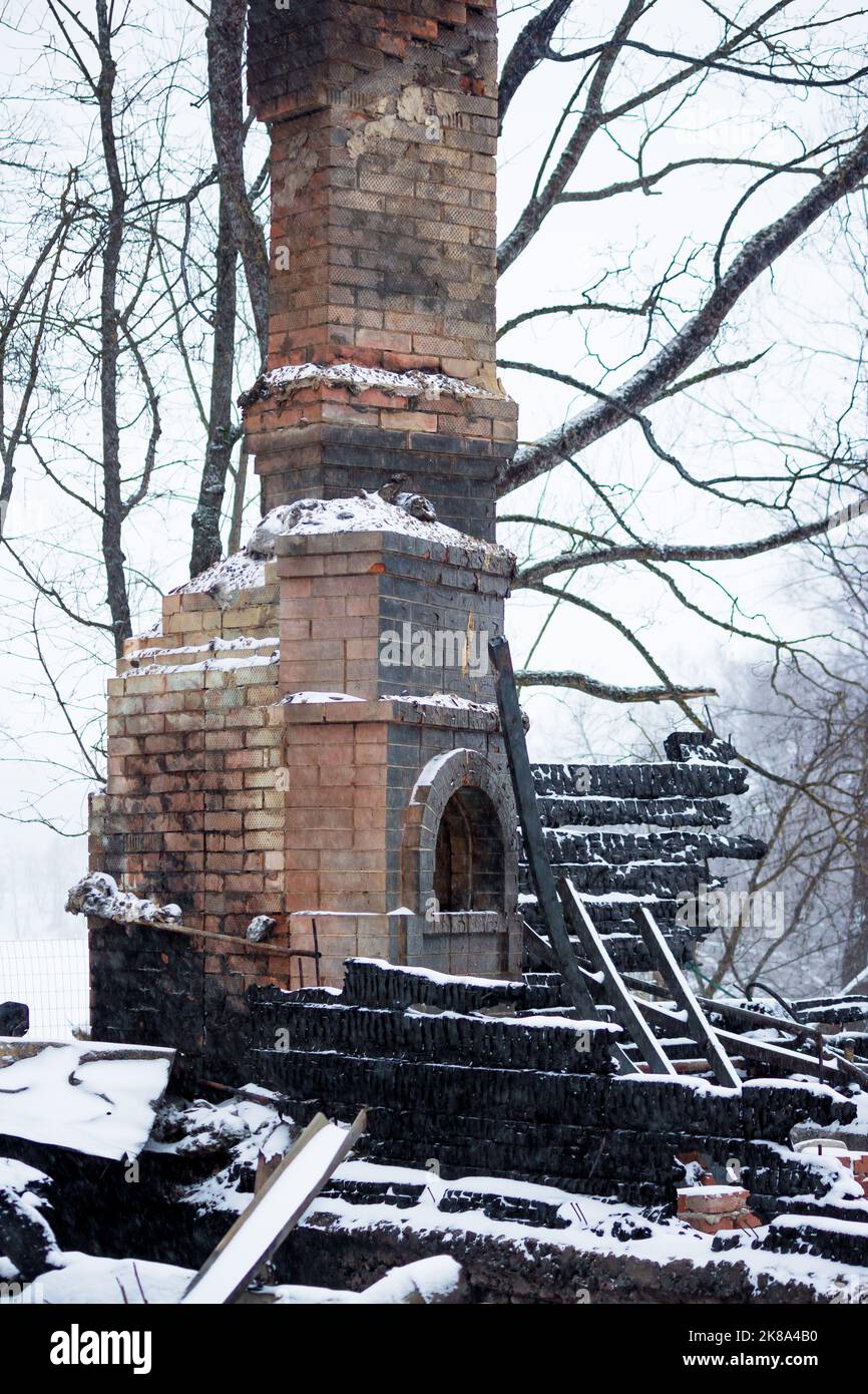 Ruins of a house after a fire with a surviving brick oven. The ruins ...
