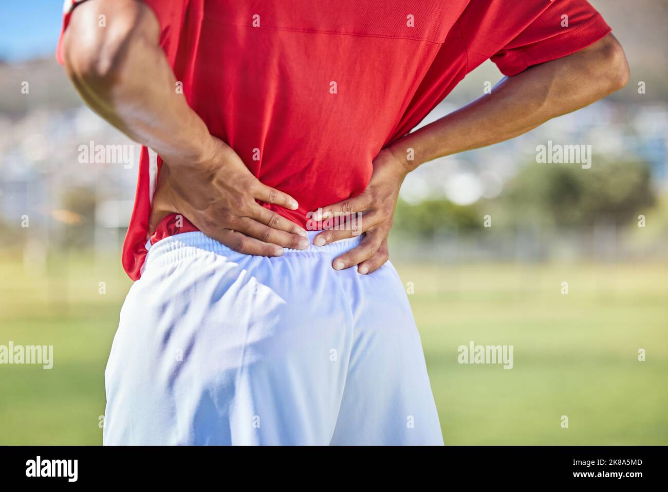Field, soccer and man with back injury in game tournament with pain ...