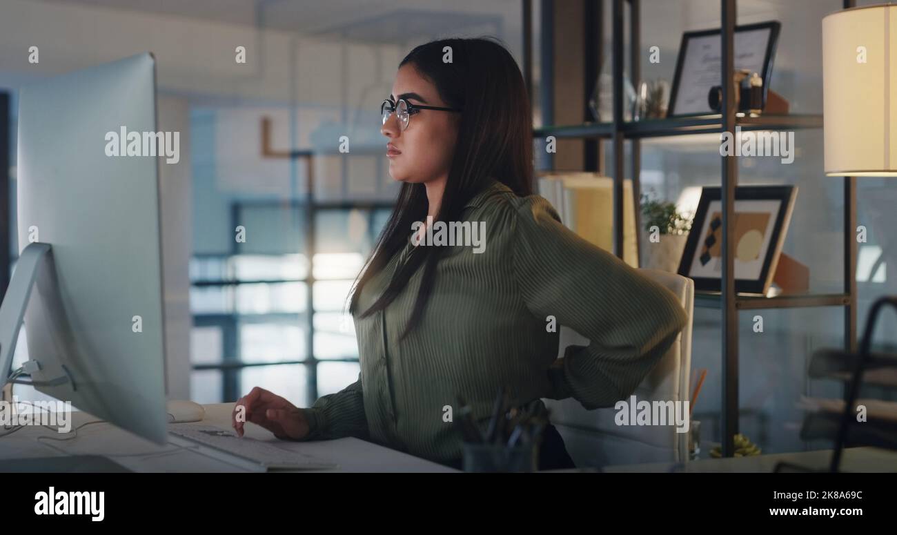 I need to work on my posture. a young businesswoman experiencing back ...