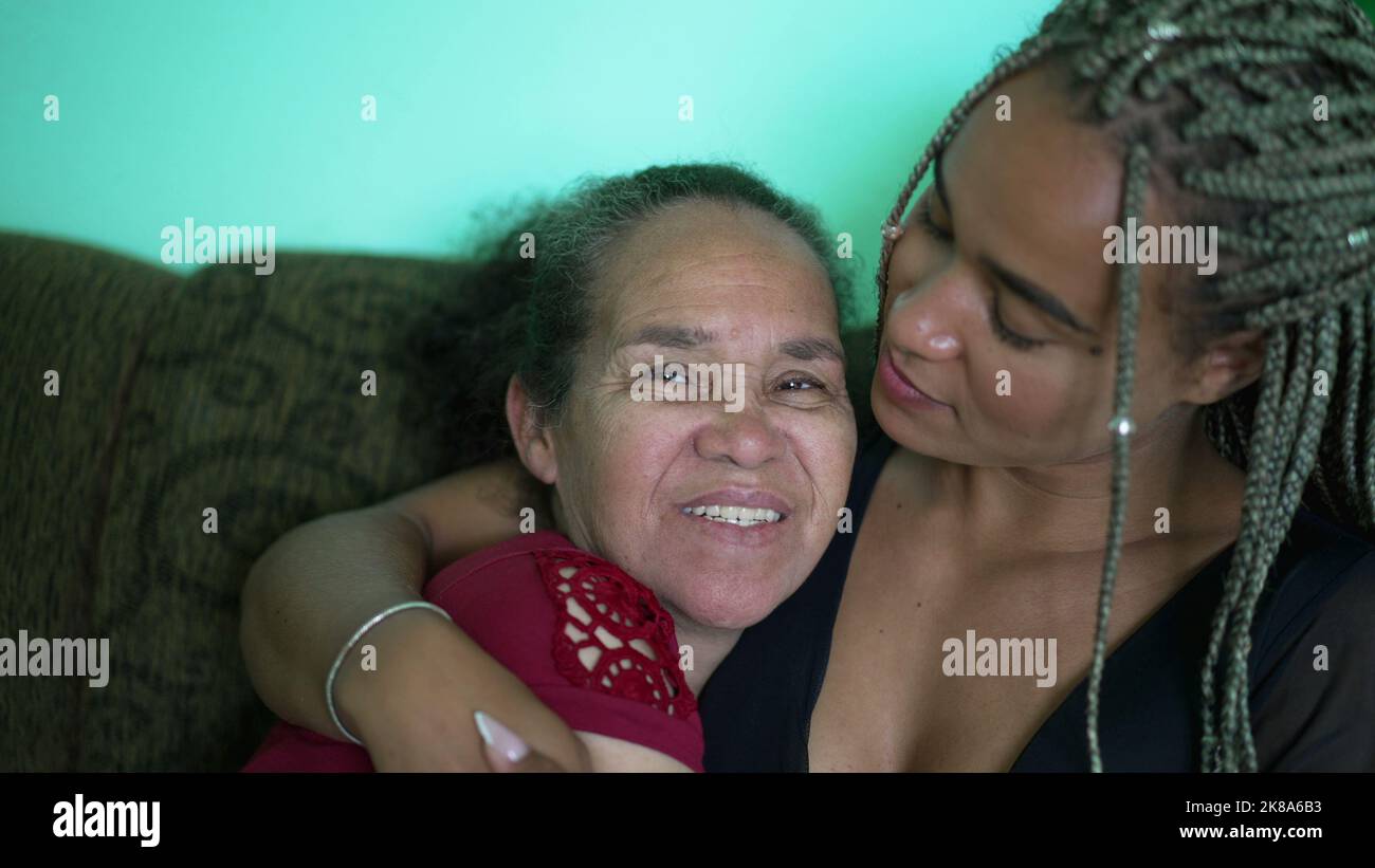An African daughter caring for senior mother. Family love and affection ...