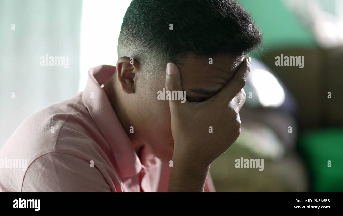 Desperate young man feeling hopeless and despair. A hispanic South ...