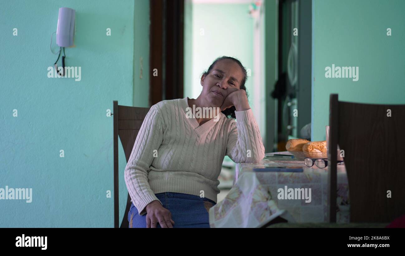 An elder senior woman sitting at home alone. A contemplative lonely ...