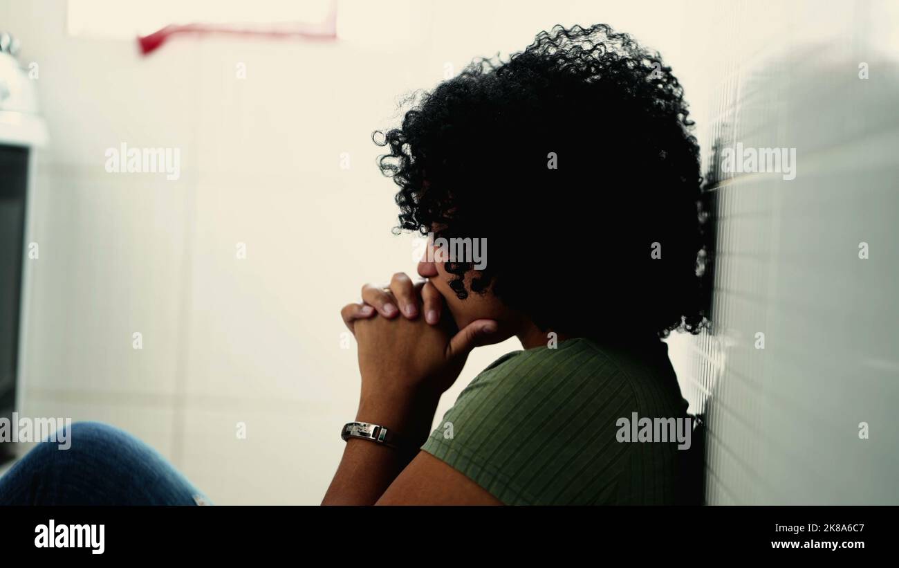 Faithful hispanic young woman praying to God during difficult times ...