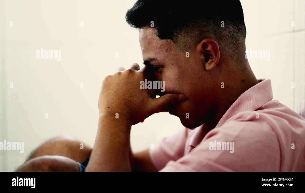 Dramatic young man suffering from depression. Hispanic person sitting ...